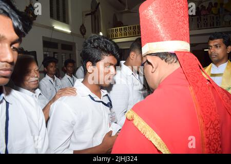 Catholic bishop is giving Confirmation sacrament Stock Photo - Alamy