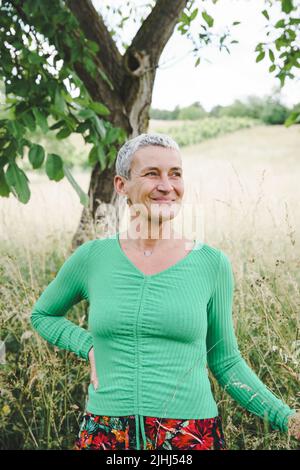 pretty, strong, powerful middle aged woman with green shirt, colorful ...