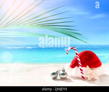 Santa Claus hat on the beach with starfish,beach slippers Stock Photo ...