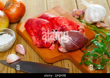 Cooking lamb lungs and liver with parsley and garlic on the table Stock ...