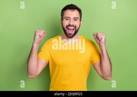 Portrait of delighted overjoyed man raise fists celebrate triumph ...