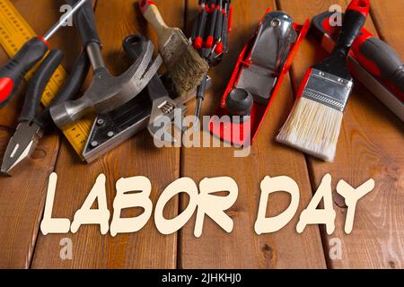 Labor day. Different tools on wooden background Stock Photo - Alamy