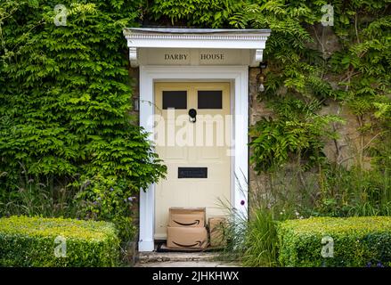 Amazon parcels left on a front doorstep of a period house, Dorset ...