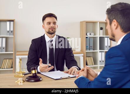 Lawyer giving a consultation to a client, providing legal advice and ...
