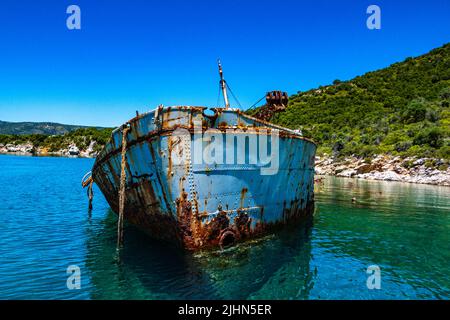 Seaside view over rusty shipwreck of an old cargo ship at Peristera ...