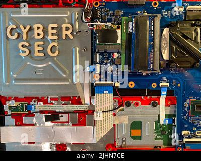 The word INFO SEC on a futuristic looking laptop motherboard. This ...