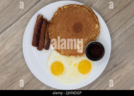 Standard American breakfast consisting of pancakes, fried eggs, and ...