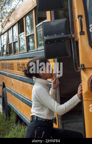 Child getting on school bus. Back to school and happy time. Little ...