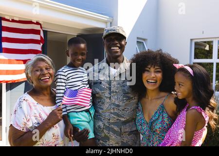 Portrait of happy multiracial army soldier with multigeneration family ...