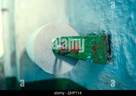 Toilet paper holder with cheap low quality single ply toilet paper ...