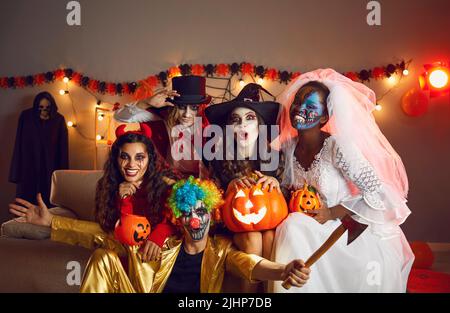 Group of friends dressed as spooky monsters having fun at Halloween ...
