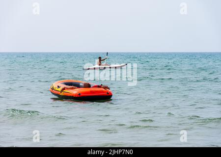 A young man kayaking in the Mediterranean sea. Kayaking sport concept ...