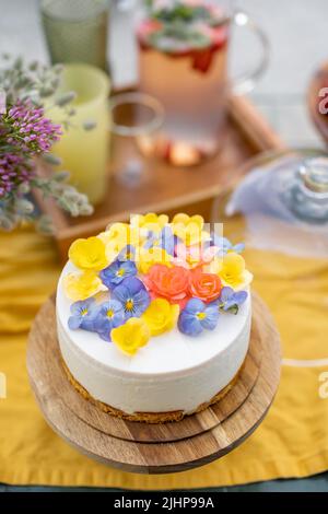 Cheesecake decorated with edible flowers Stock Photo - Alamy