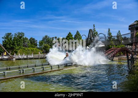 People ride SuperSplash, a water ride at Plopsaland in De Panne, in ...