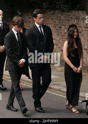 Son Hugo (left) and husband Sebastien Bowen, walk with family behind ...