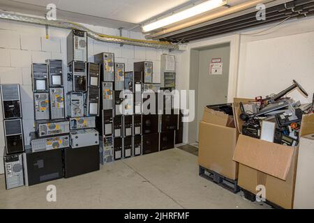 in a computer room there are many broken computers and e-waste for ...