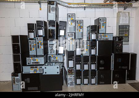 in a computer room there are many broken computers and e-waste for ...