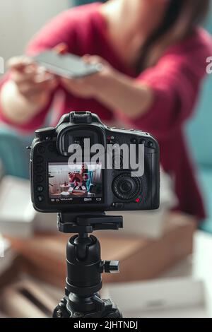 woman blogger makes video of unpacking gadgets at home Stock Photo - Alamy