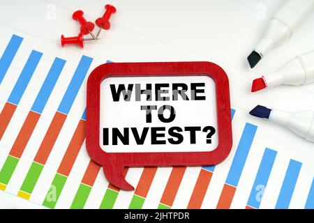 Business and economy concept. There are markers, charts and a sign on ...