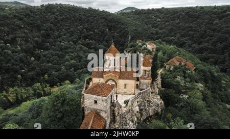An aerial view of Motsameta Monastery surrounded by dense forest in ...
