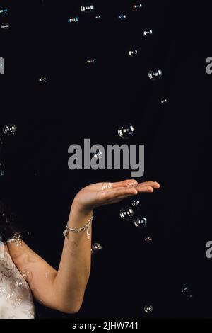 woman holding up flattened hand gesturing to floating, touchable ...