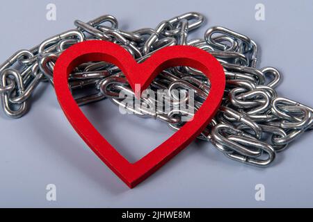 Heart shape with metallic chain around it in a blue background Stock ...