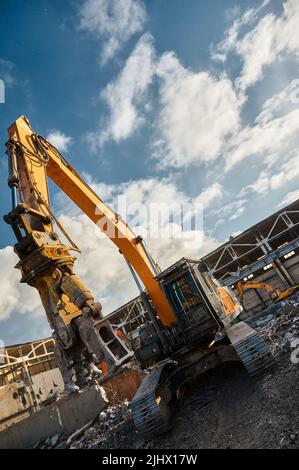 A construction excavator equipped with a hydraulic concrete breaker ...