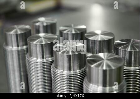 Metal pins with screw thread on table in light storehouse Stock Photo ...