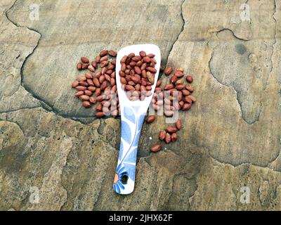 FOOD GRAIN PUT IN PLASTIC BIG SPOON ISOLATED ON STONE BACKGROUND Stock ...