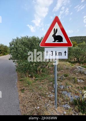 Rabbits crossing warning road sign placed along a road in Croatia ...