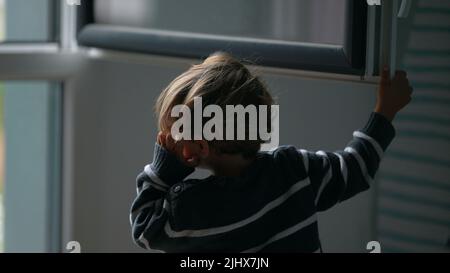 Little boy shutting window home. Child closes window Stock Photo - Alamy