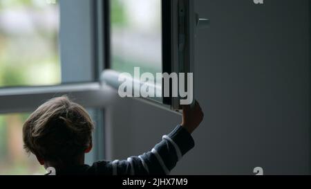 Child closing window. Toddler closes window Stock Photo - Alamy