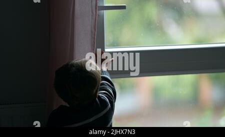 Child closing window. Toddler closes window Stock Photo - Alamy