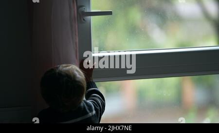 Child closing window. Toddler closes window Stock Photo - Alamy