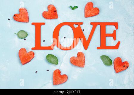 Watermelon hearts, wooden word love on light stone background. Summer ...