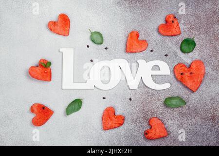 Watermelon hearts, wooden word love on light stone background. Summer ...