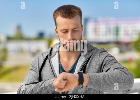 man with fitness tracker in city Stock Photo - Alamy