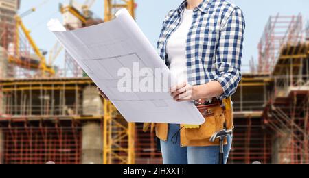 female builder with blueprint and working tools Stock Photo - Alamy