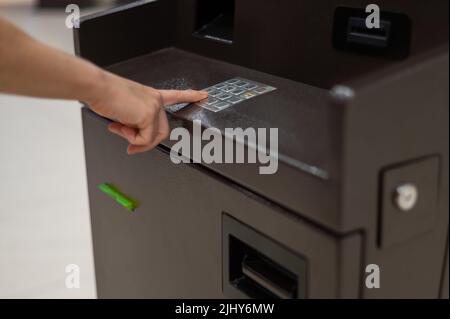Faceless woman dialing bank card pin at ATM Stock Photo - Alamy