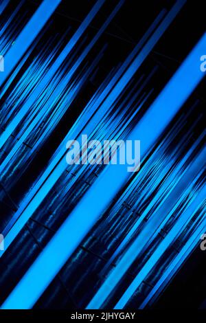 Abstract angled light poles in pink and blue Stock Photo - Alamy