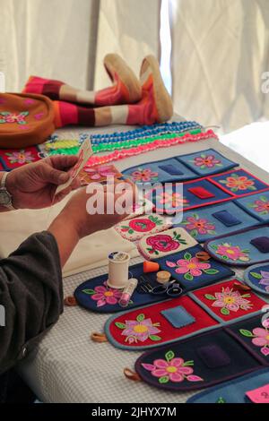 Indigenous Dene woman sewing traditional beaded handicrafts ...