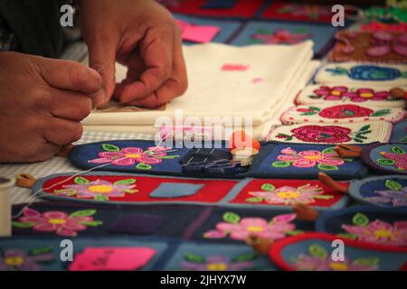 Indigenous Dene woman sewing traditional beaded handicrafts ...