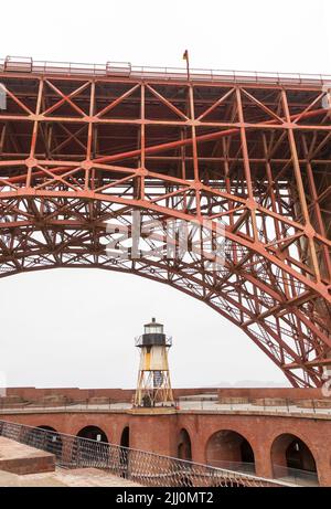 Fort Point lighthouse beneath the south anchorage of the Golden Gate ...