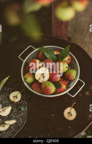 Many ripe pears in a colander on wooden garden table Stock Photo - Alamy