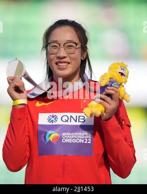 Gold medalist Bin Feng, of China, left, celebrates with silver medalist ...