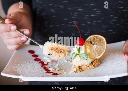 Customer eating sweet creamy orange dessert Stock Photo - Alamy