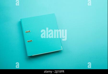 Blue hardcover office folder on yellow background Stock Photo - Alamy