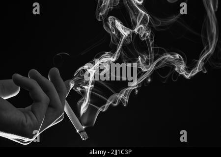 Tobacco is wacko. Steaming cigarette in male hand. Smoking habit ...