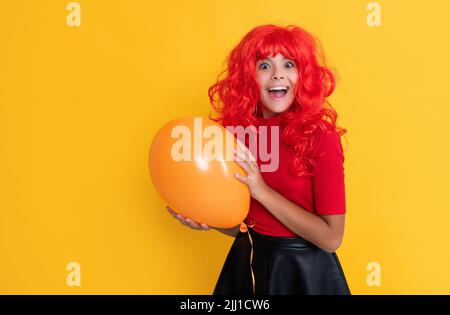 glad redhead girl with curly hair on blue background Stock Photo - Alamy
