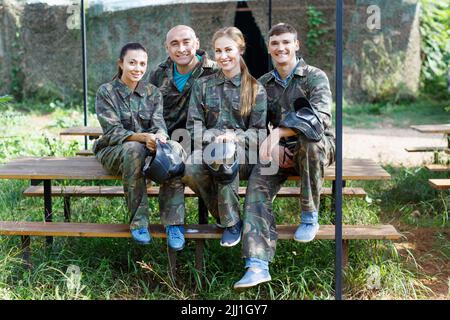 Portrait of paintball players wearing uniform and holding guns ready ...